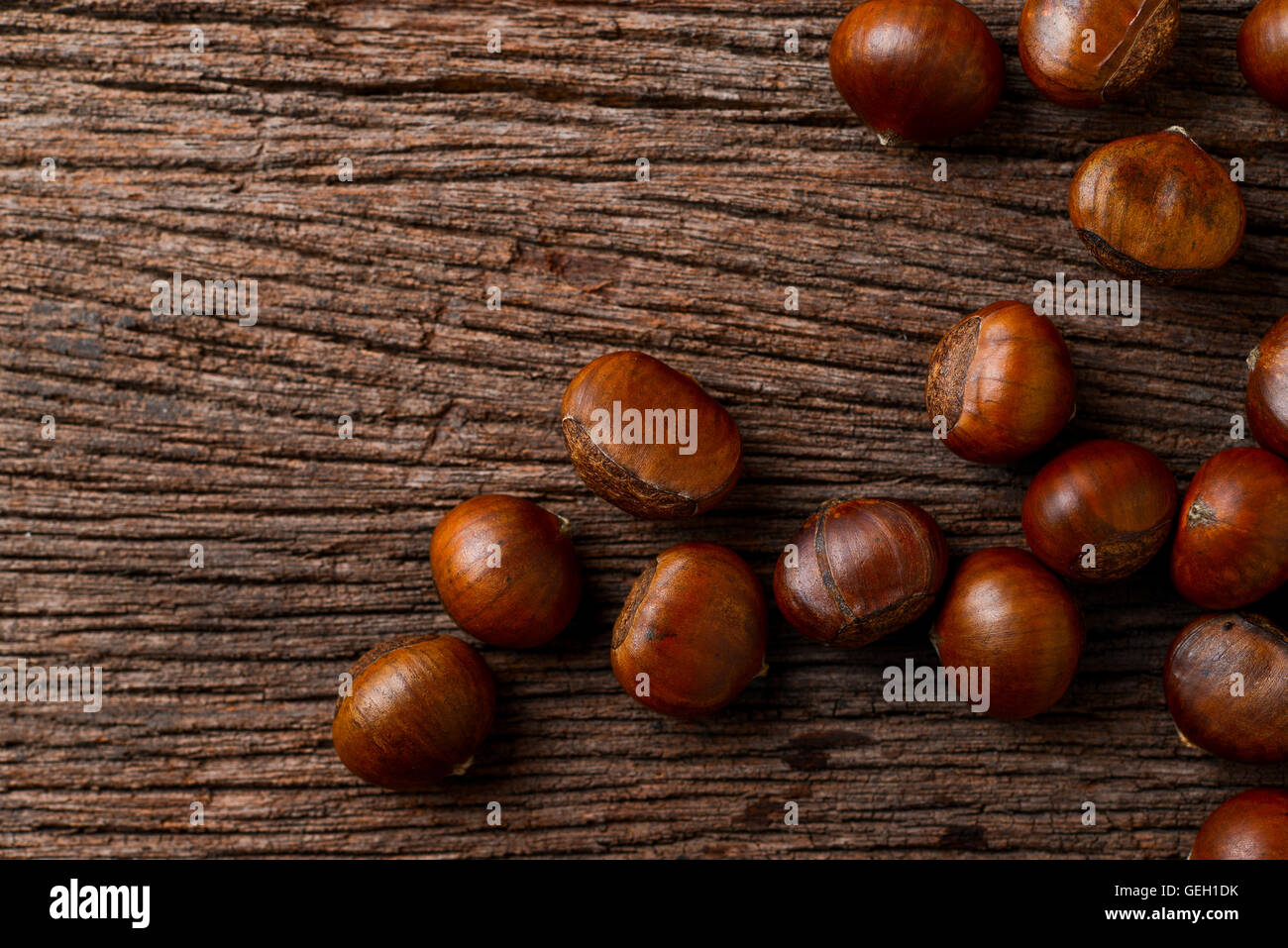 roasted chestnuts on wood background Stock Photo - Alamy