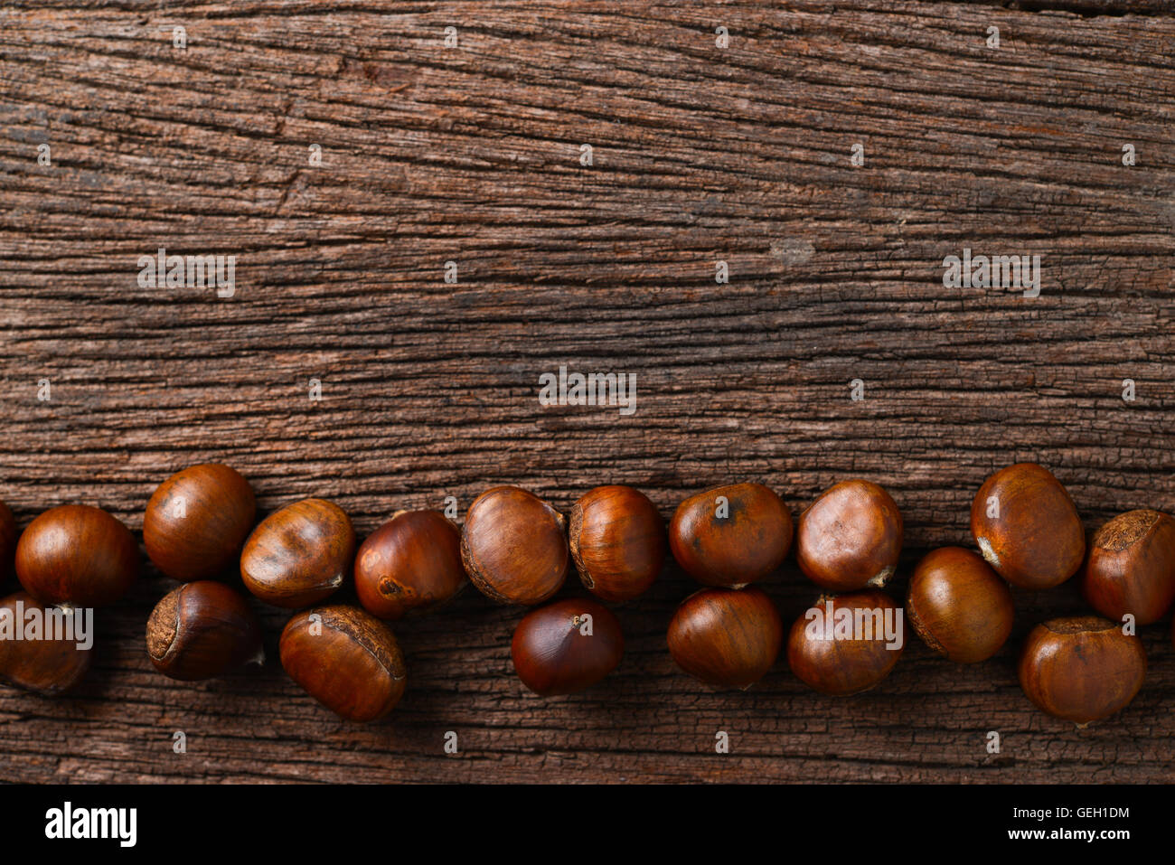 roasted chestnuts on wood background Stock Photo - Alamy