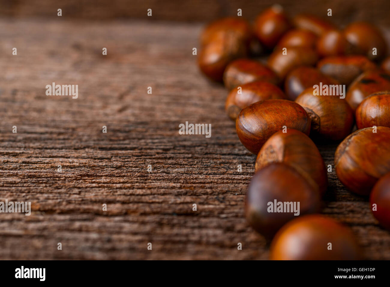 roasted chestnuts on wood background Stock Photo - Alamy