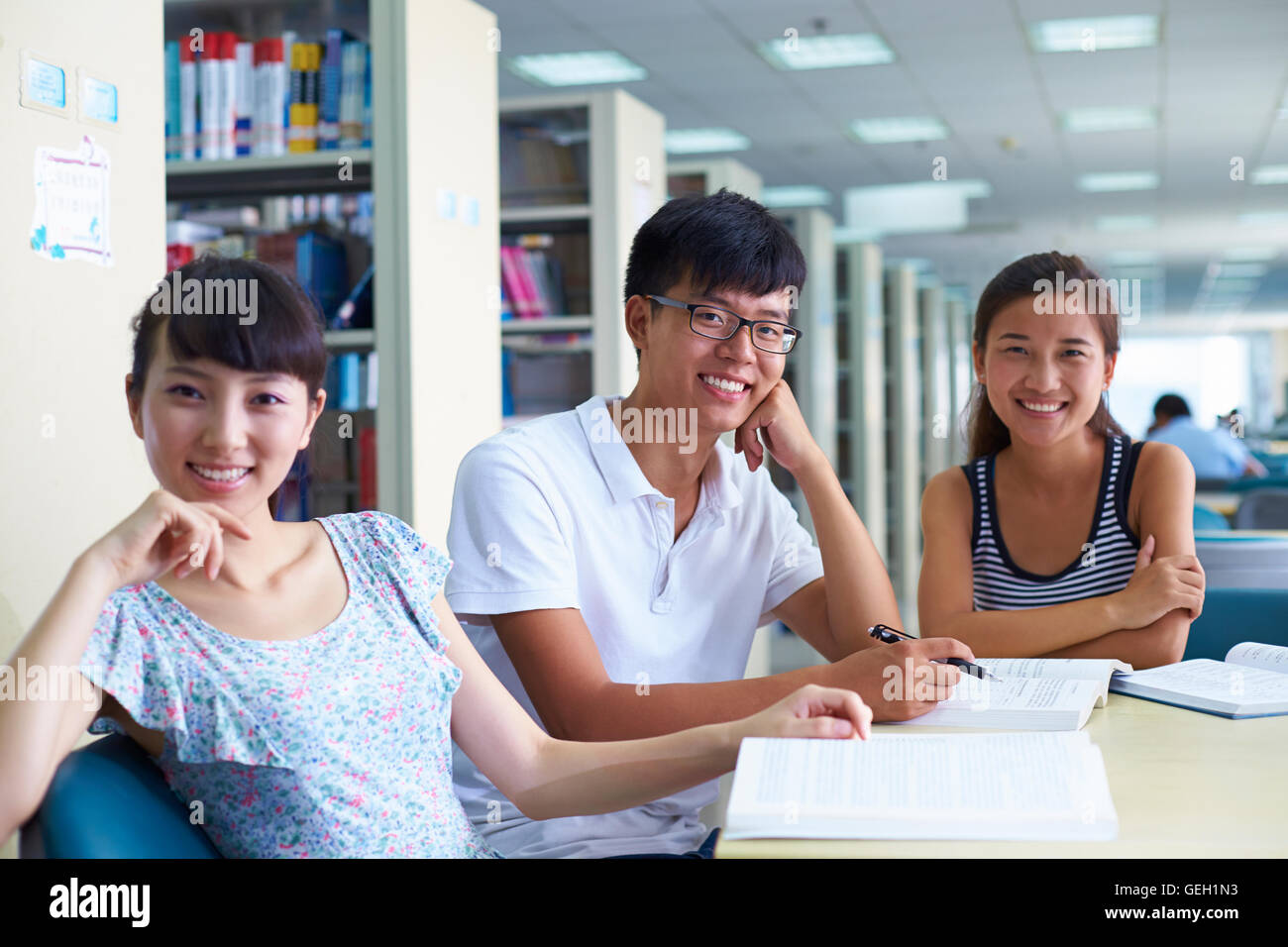 Happy young Chinese or Asian college students study together in the ...