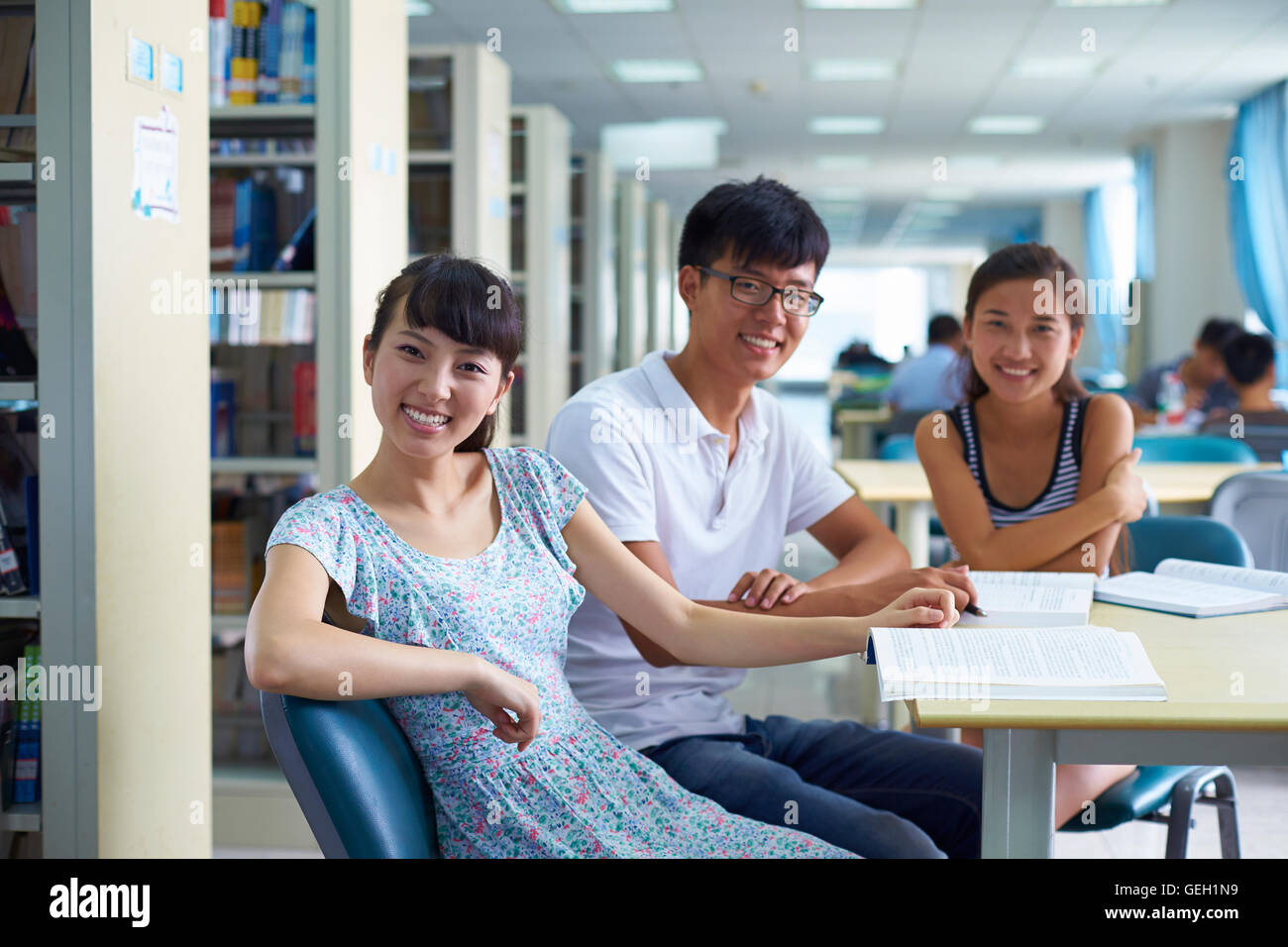 Happy young Chinese or Asian college students study together in the ...