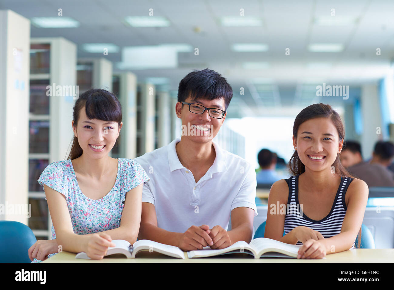 Young asian or Chinese college students study together in the library ...