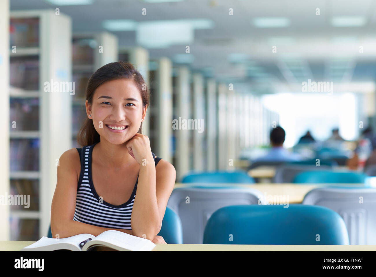 one pretty young Asian or Chinese college student study in the library ...