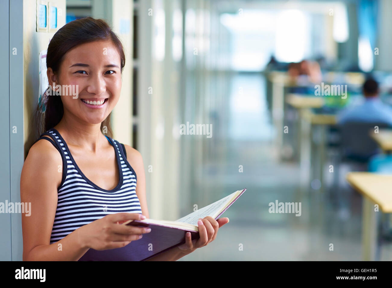 one pretty young Asian or Chinese college student study in the library ...