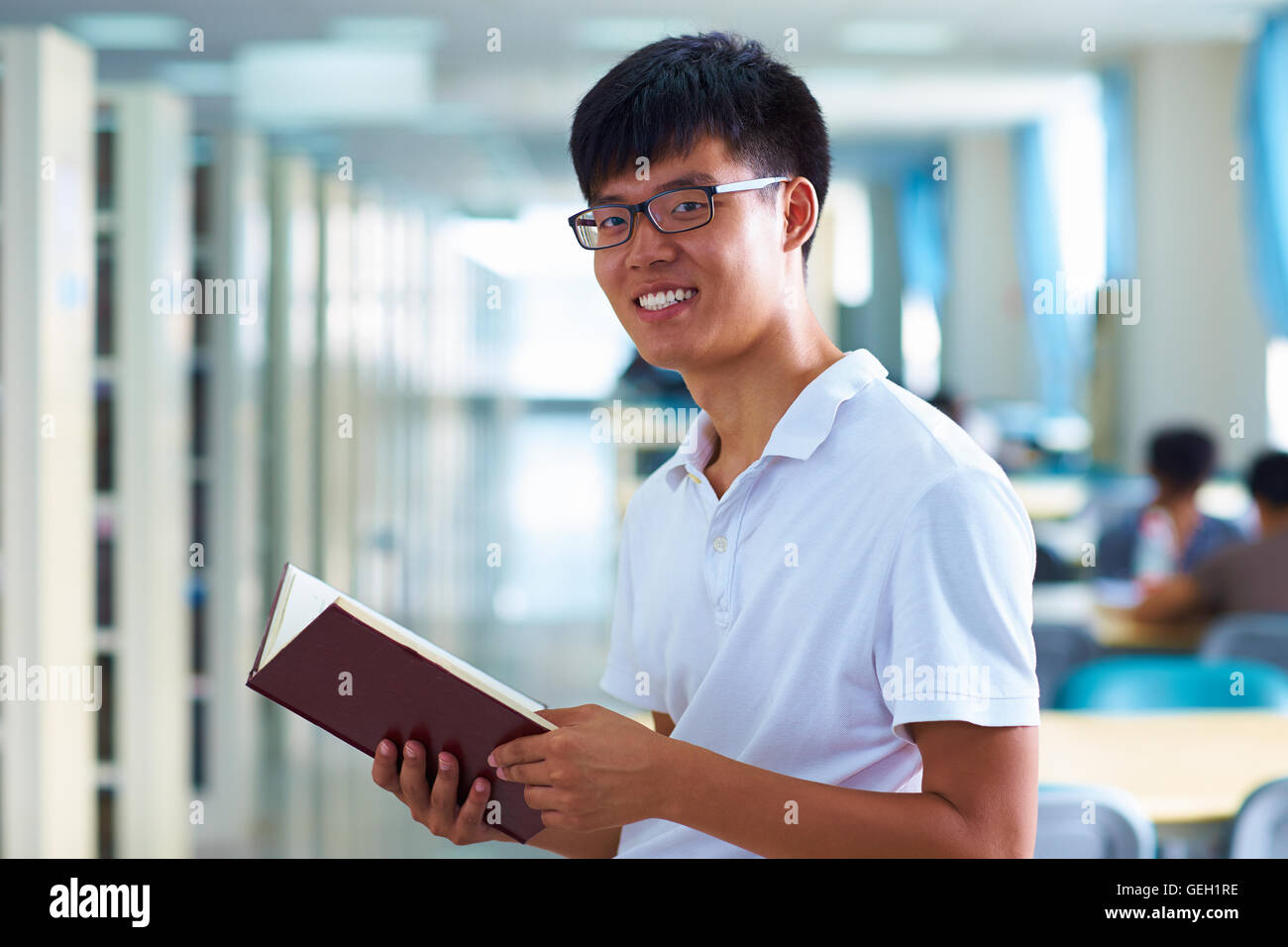 One young male asian or Chinese college students looking at camera ...