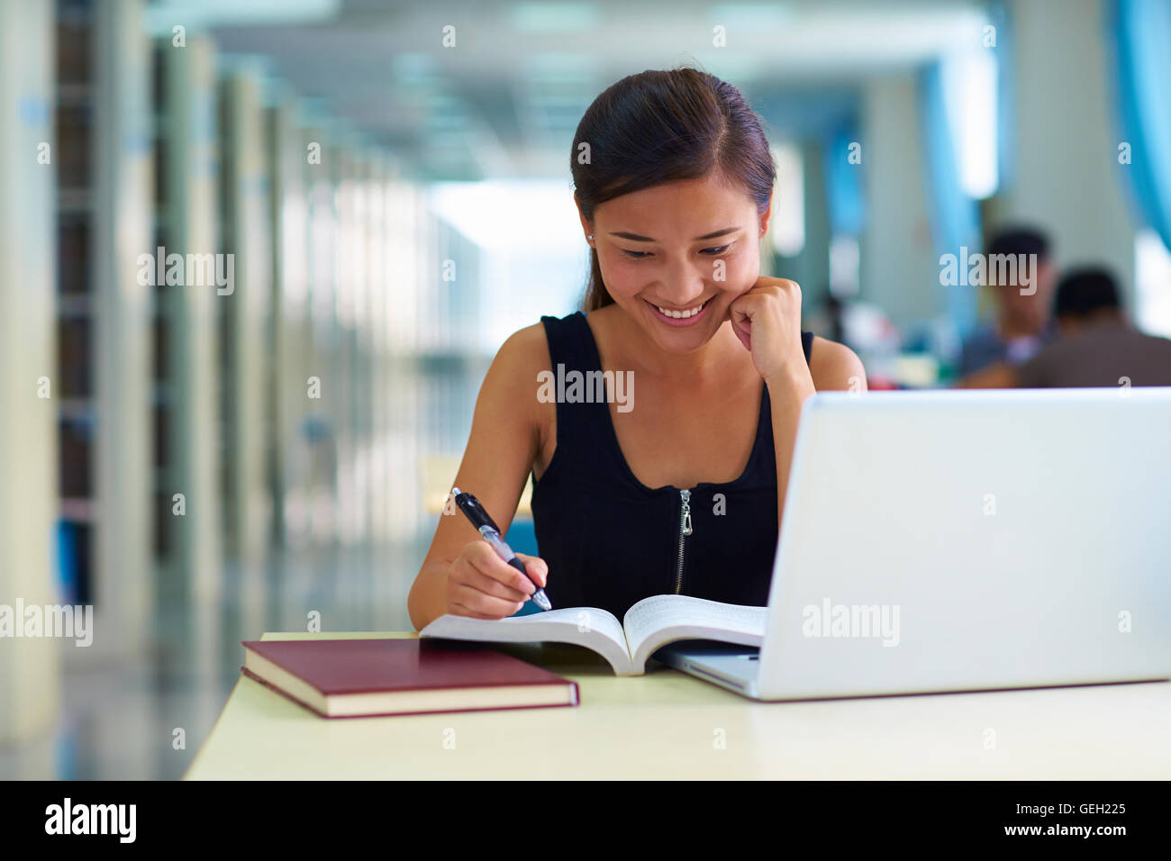one pretty young Asian or Chinese college student study in the library ...