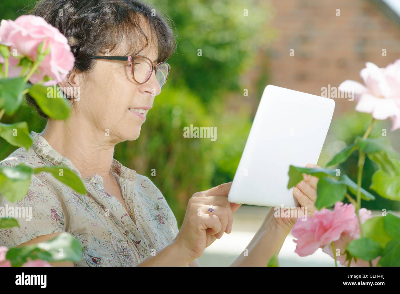 a portrait of a mature woman with a tablet Stock Photo - Alamy