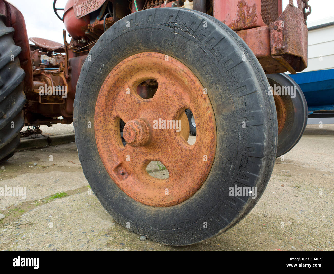 Rusty front wheel of old tractor Stock Photo - Alamy