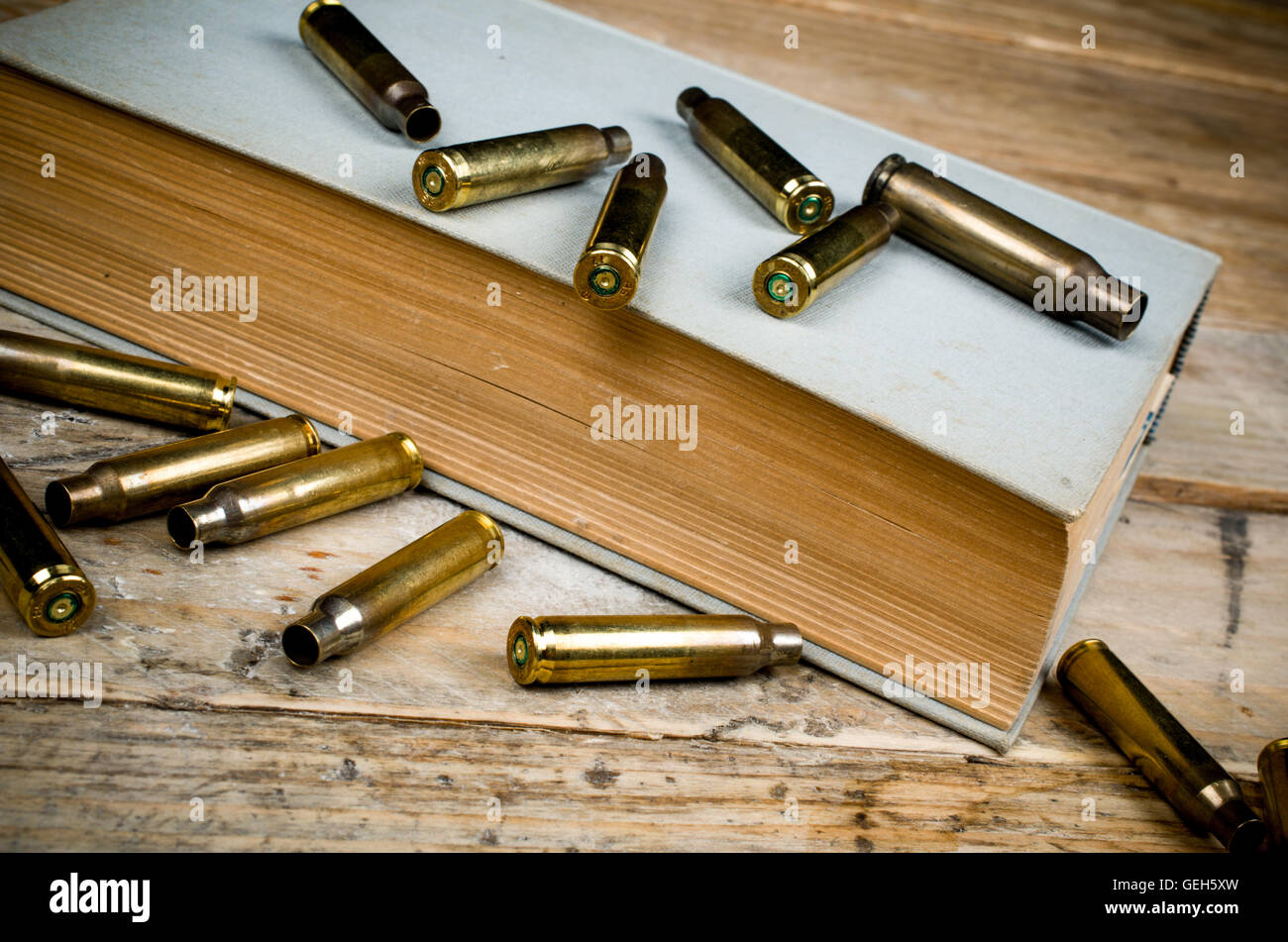 Still life with old book and bullets, a mystery novel concept Stock ...