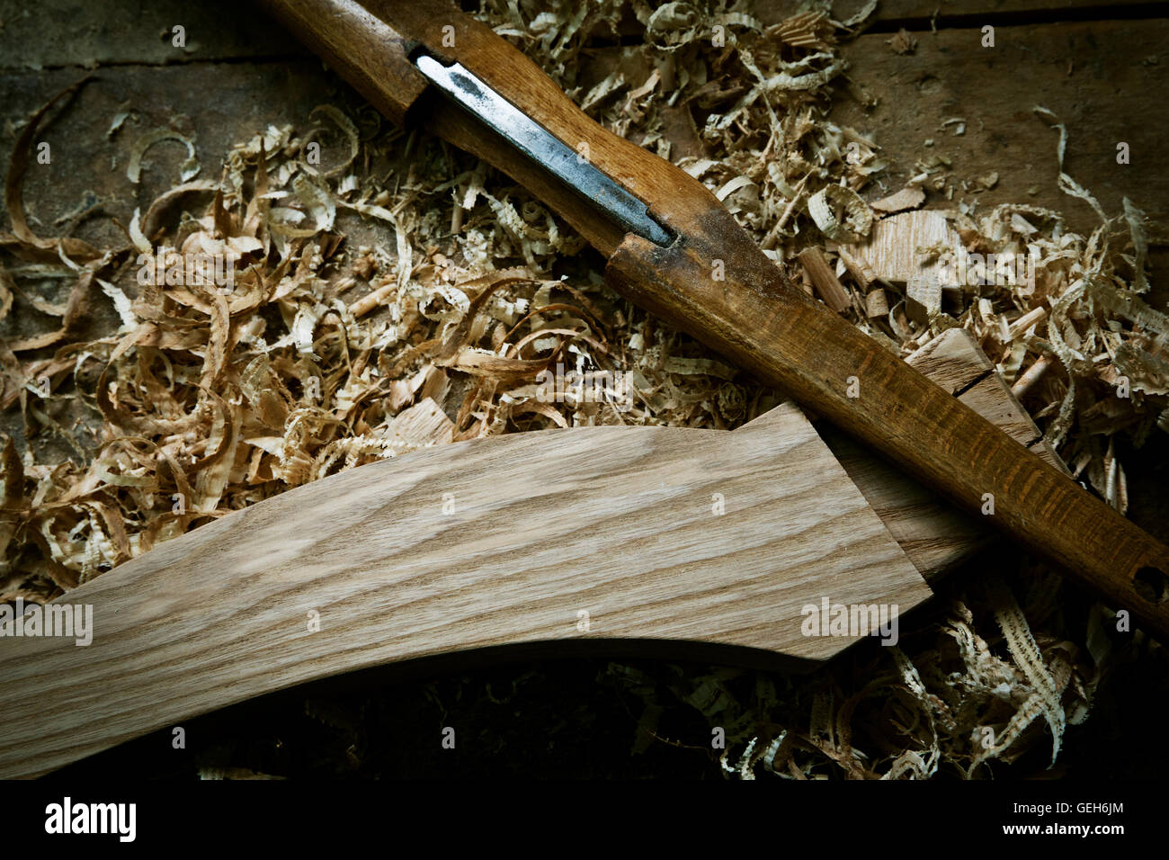 A chisel and wooden object with wood shavings, on a workbench Stock ...