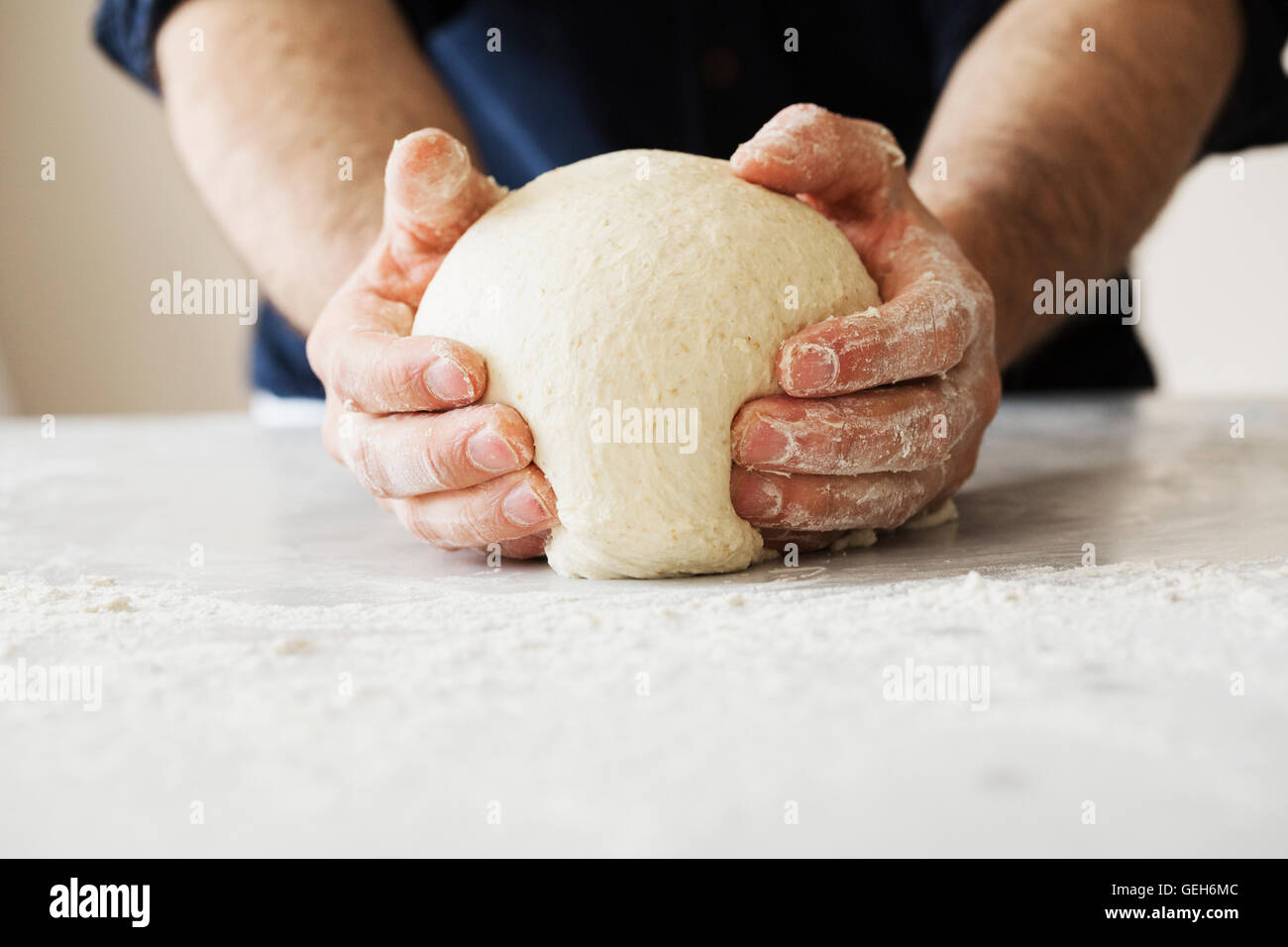 Close up of a baker kneading and shaping bread dough into a ball Stock ...
