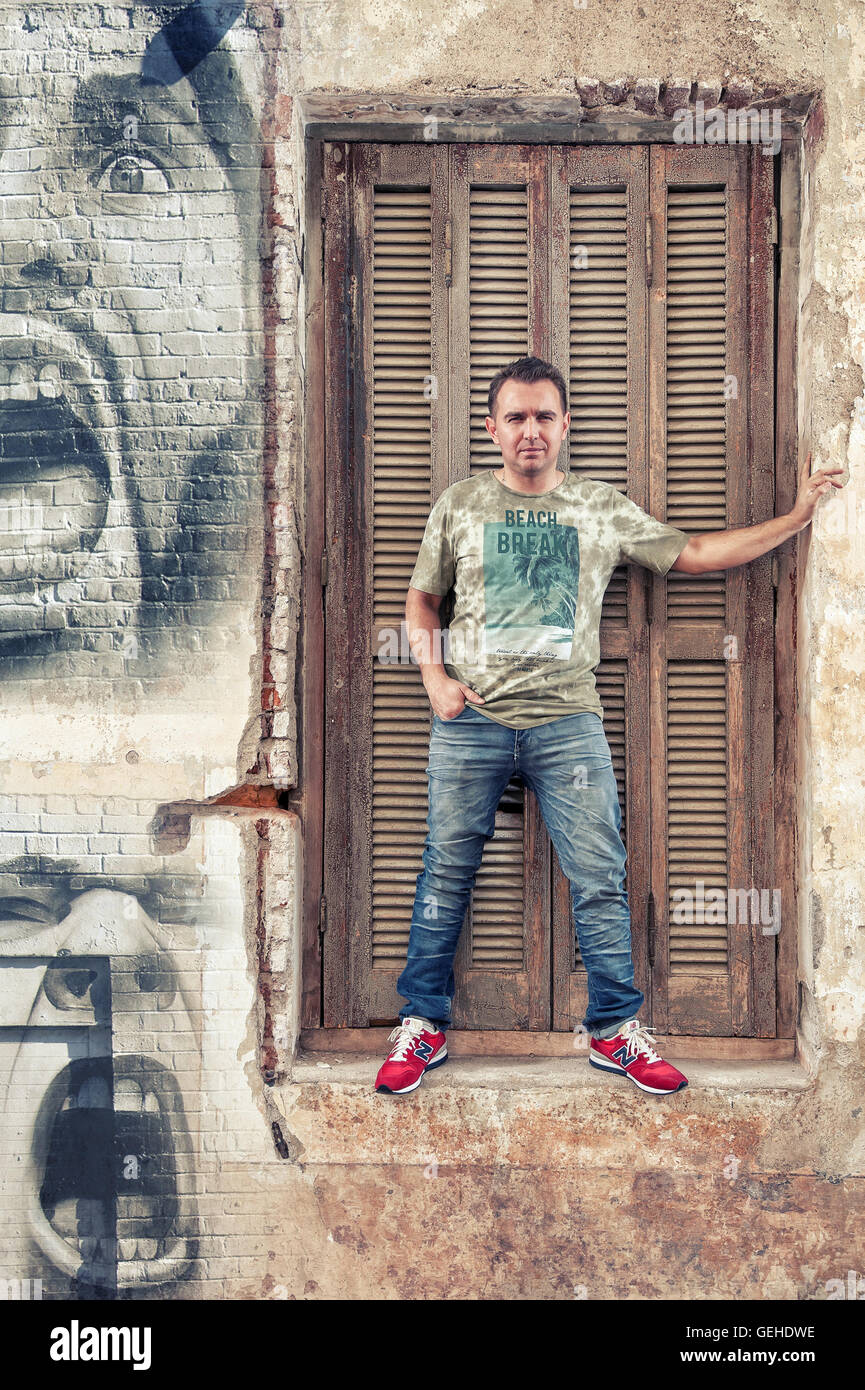 Man on window ledge hi-res stock photography and images - Alamy