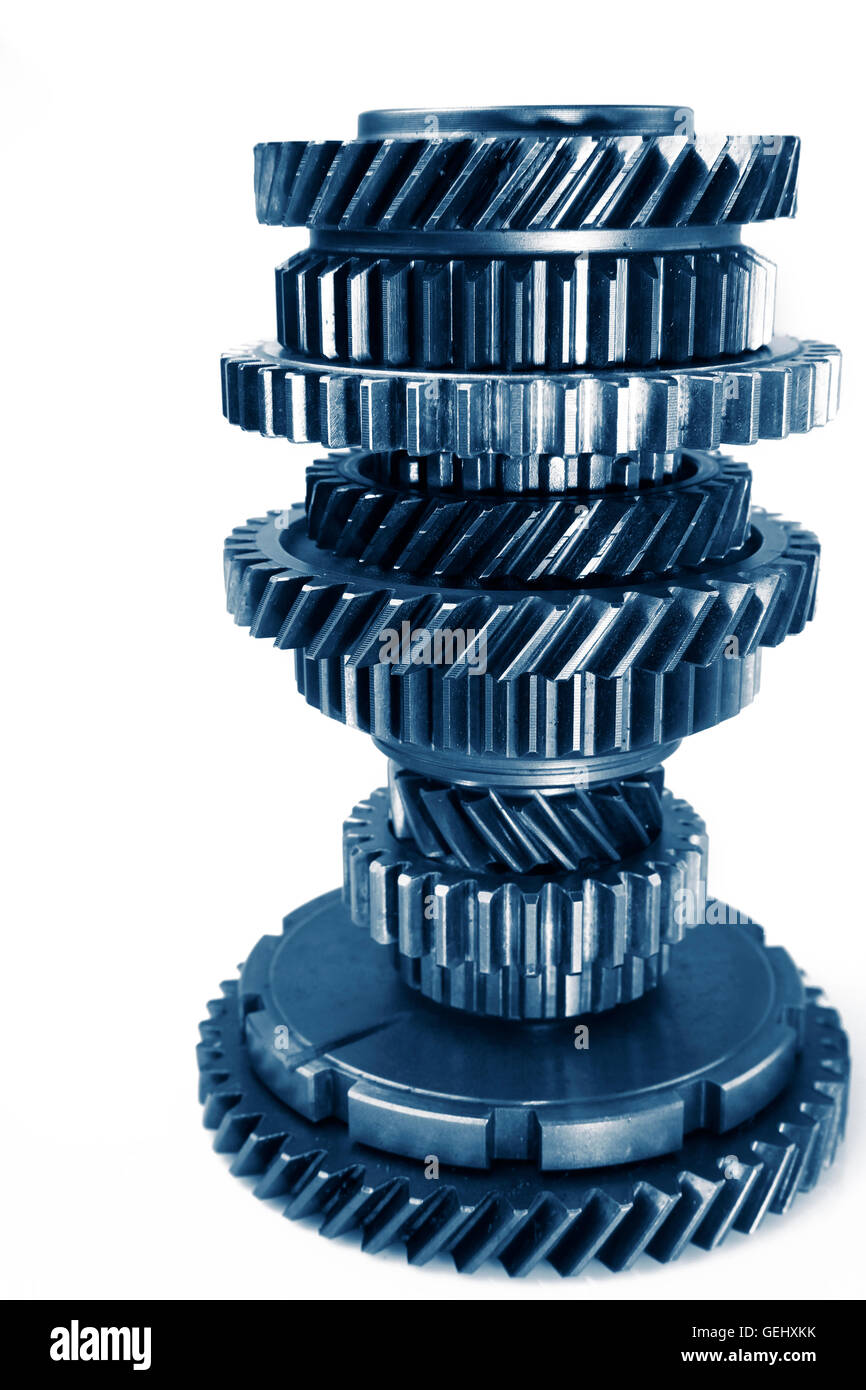 Steel cogs together on plain background Stock Photo - Alamy
