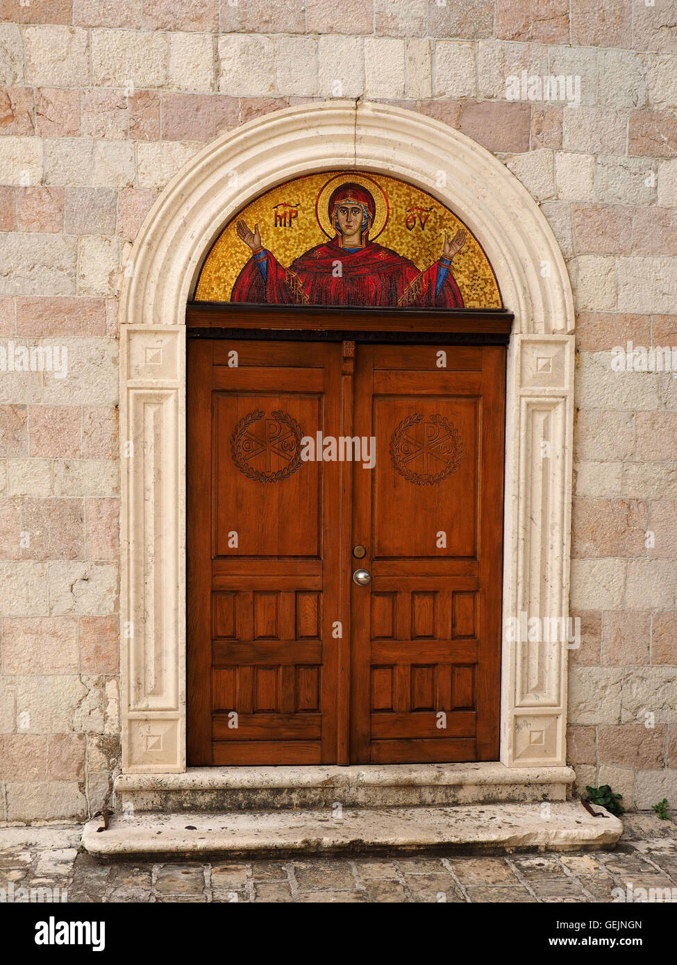 Orthodox Church doorway with mosaic icon in arched panel above carved ...