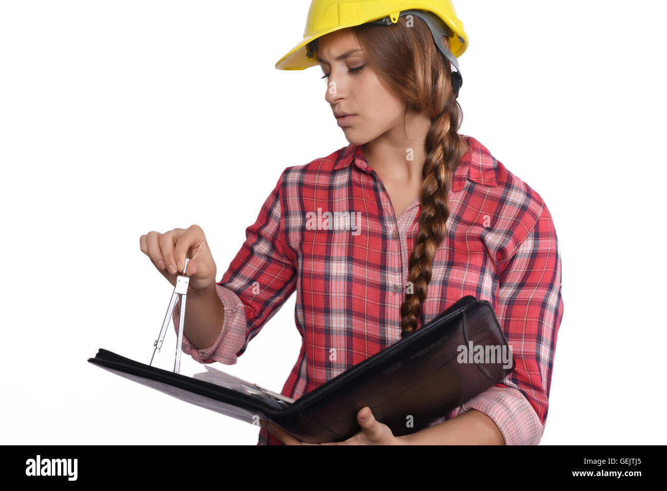 Portrait of beautiful woman construction worker reading blueprints and ...