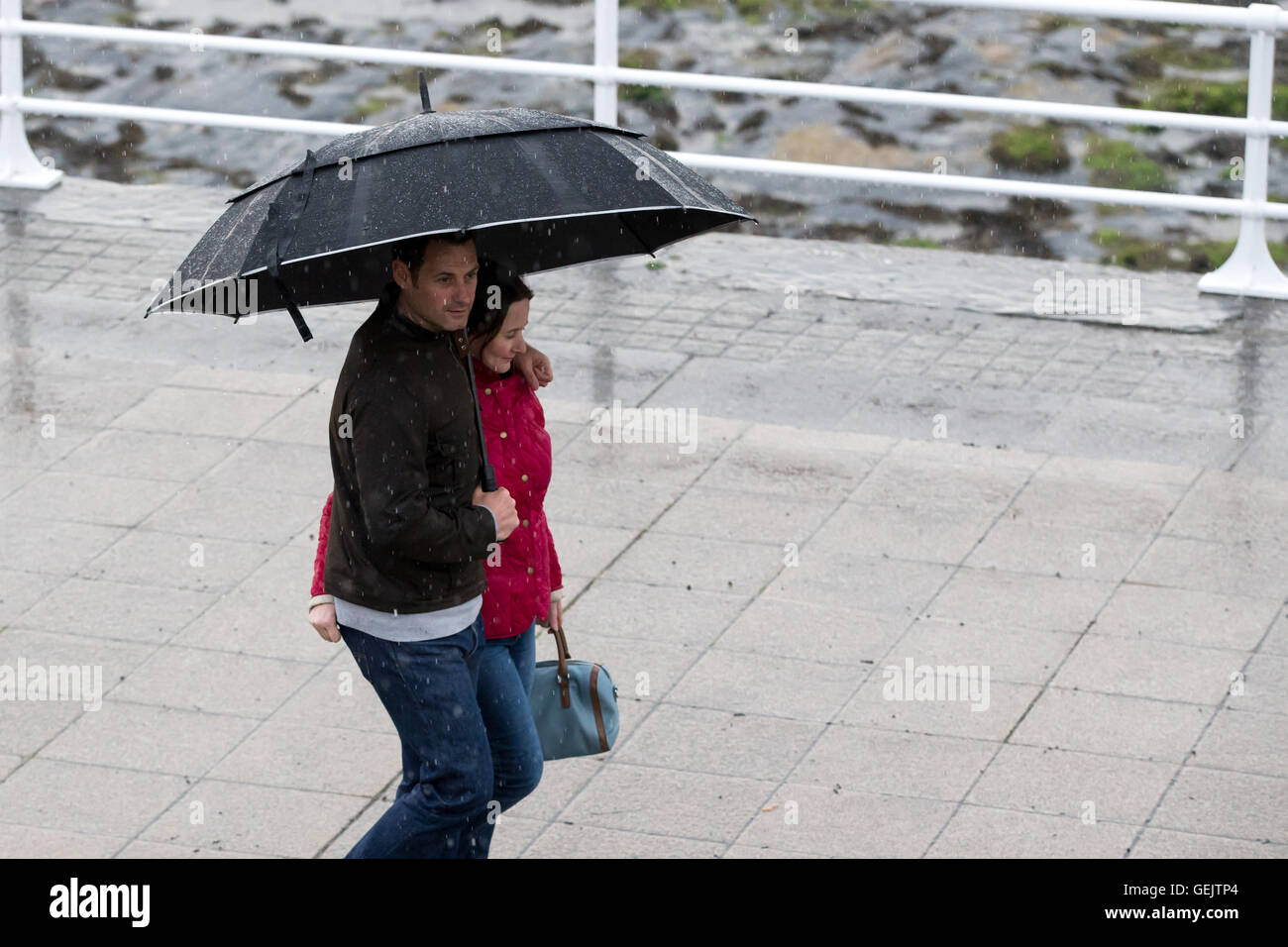 Man walking in rain umbrella hi-res stock photography and images - Alamy