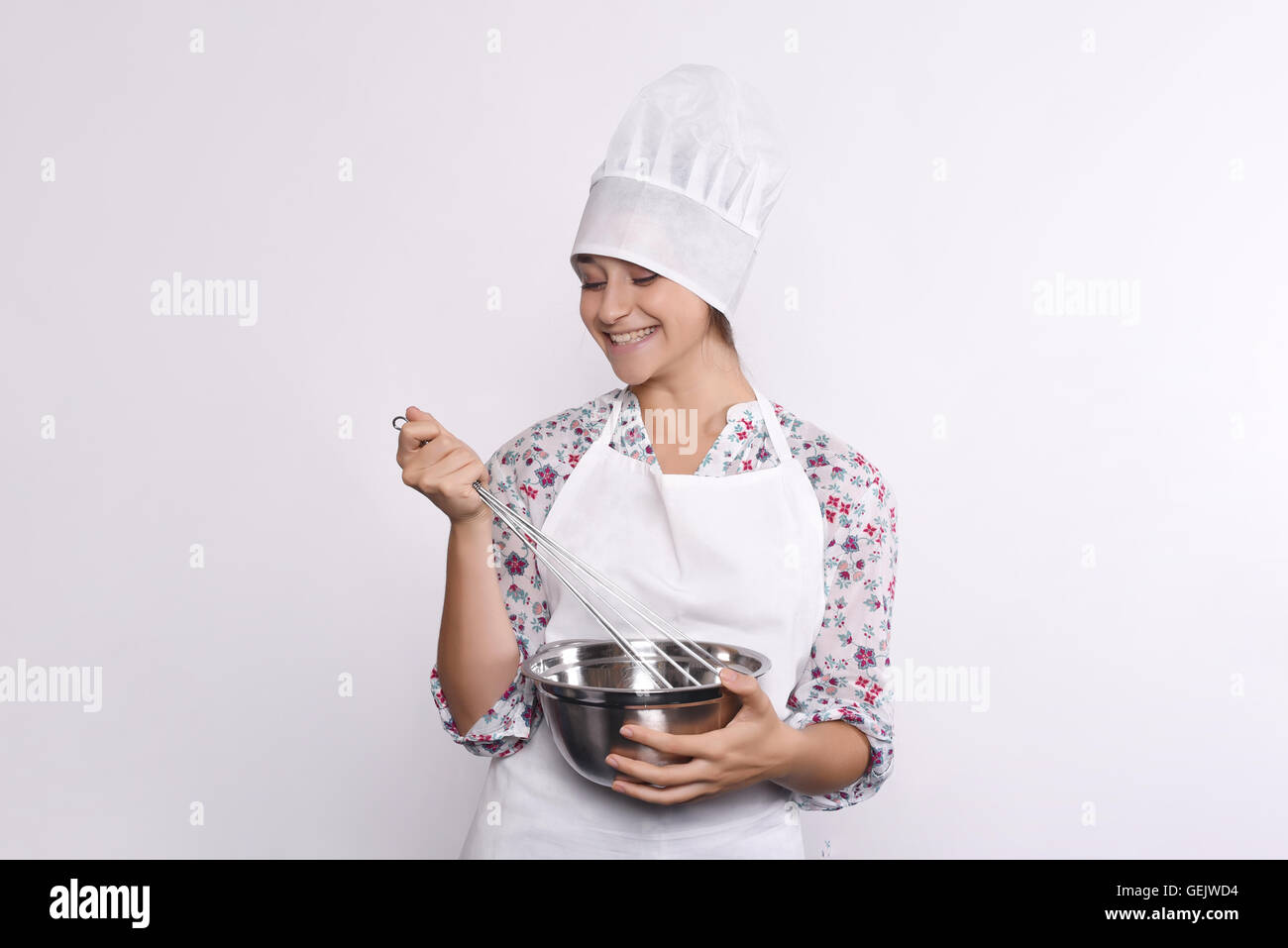 Young beautiful woman cooking. Isolated white background Stock Photo ...