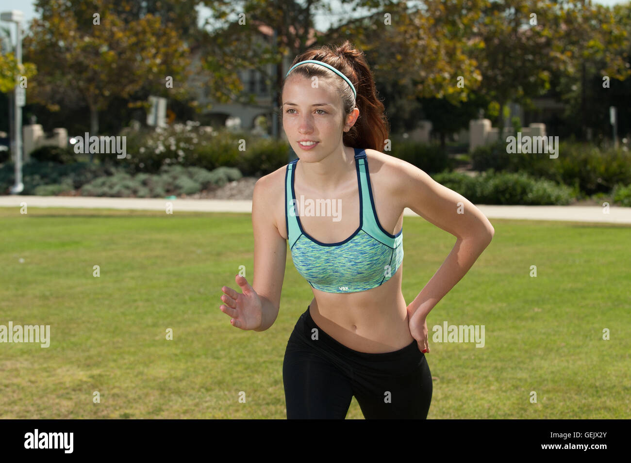 Muscular teen athlete ready to run on grass Stock Photo - Alamy