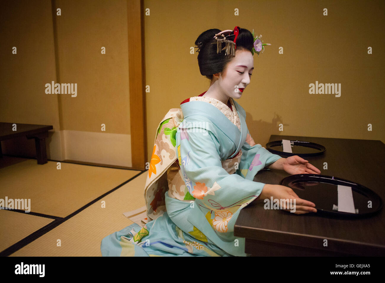 'maiko' (geisha apprentice)working in a tea house.Geisha's distric of ...