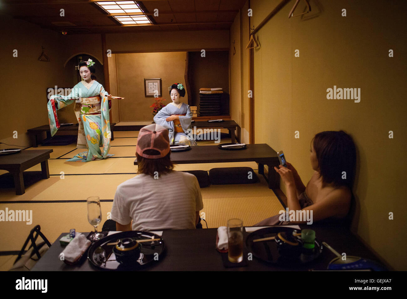 'maikos' (geisha apprentice) dancing in a tea house.Geisha's distric of ...