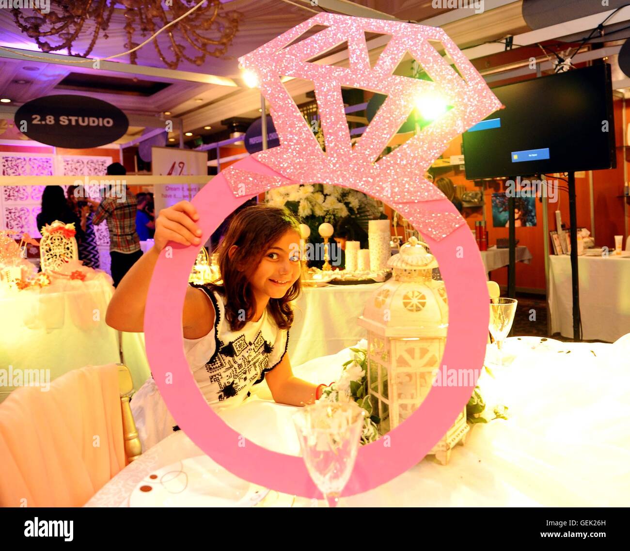 Damascus. 25th July, 2016. A Syrian girl poses for photos behind a ...