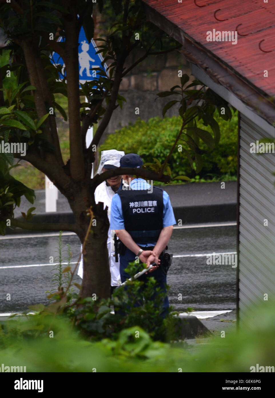 Tokyo, Japan. 26th July, 2016. A Japanese police officer talks to a ...