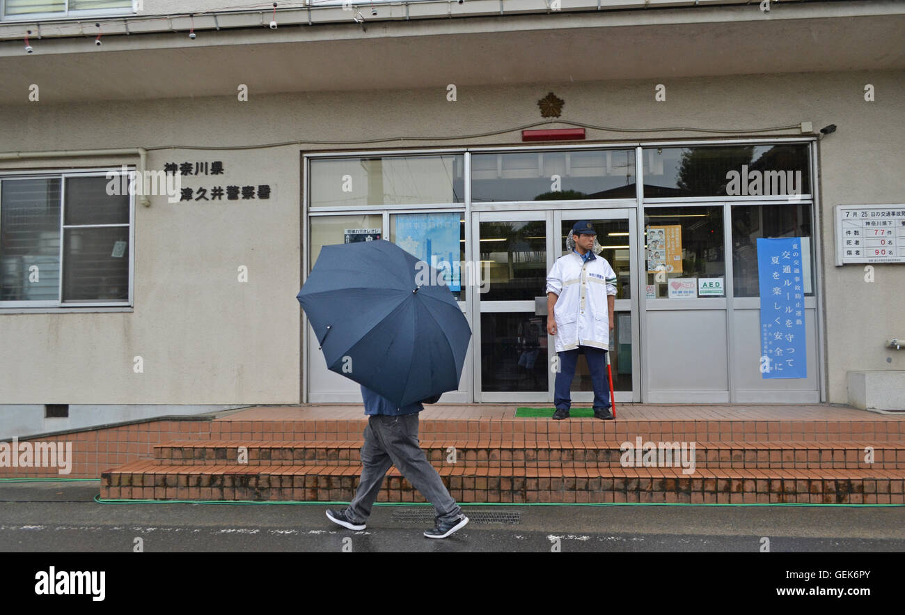 Tokyo, Japan. 26th July, 2016. A Japanese police officer stands infront ...