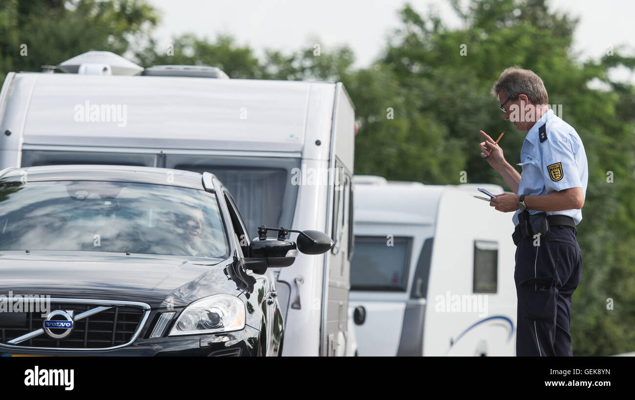 Neuenburg, Germany. 22nd July, 2016. A police officer inspects a camper ...