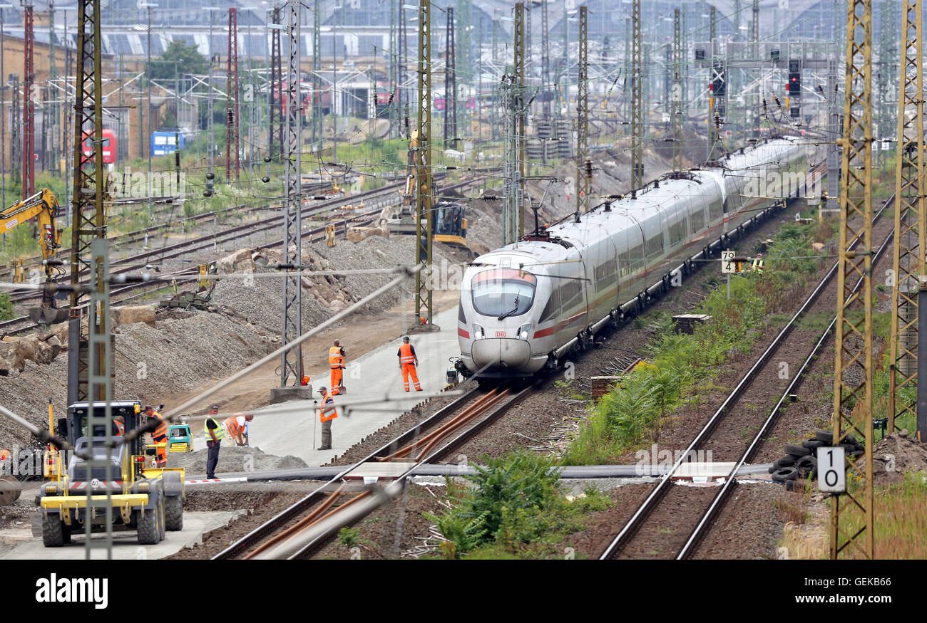 Construction workers build new railroad tracks during ongoing railway ...