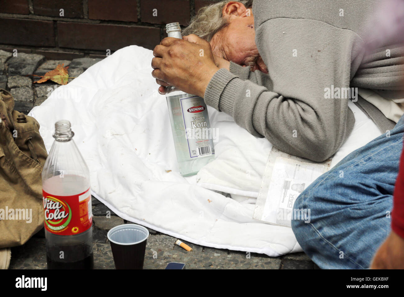Berlin, Germany. 27th July, 2016. A homeless man lies outside the ...
