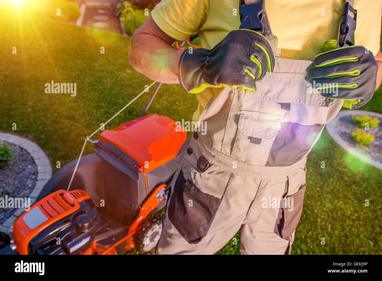 Professional Lawn Mowing and Landscaping. Pro Gardener with His Grass ...