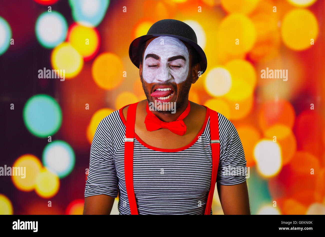 Pantomime man wearing facial paint posing for camera interacting making ...