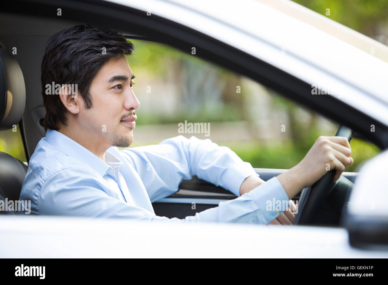 Young Chinese man driving car Stock Photo - Alamy