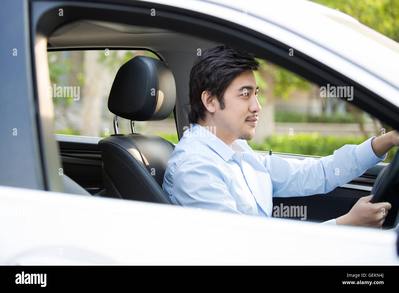 Young Chinese man driving car Stock Photo - Alamy