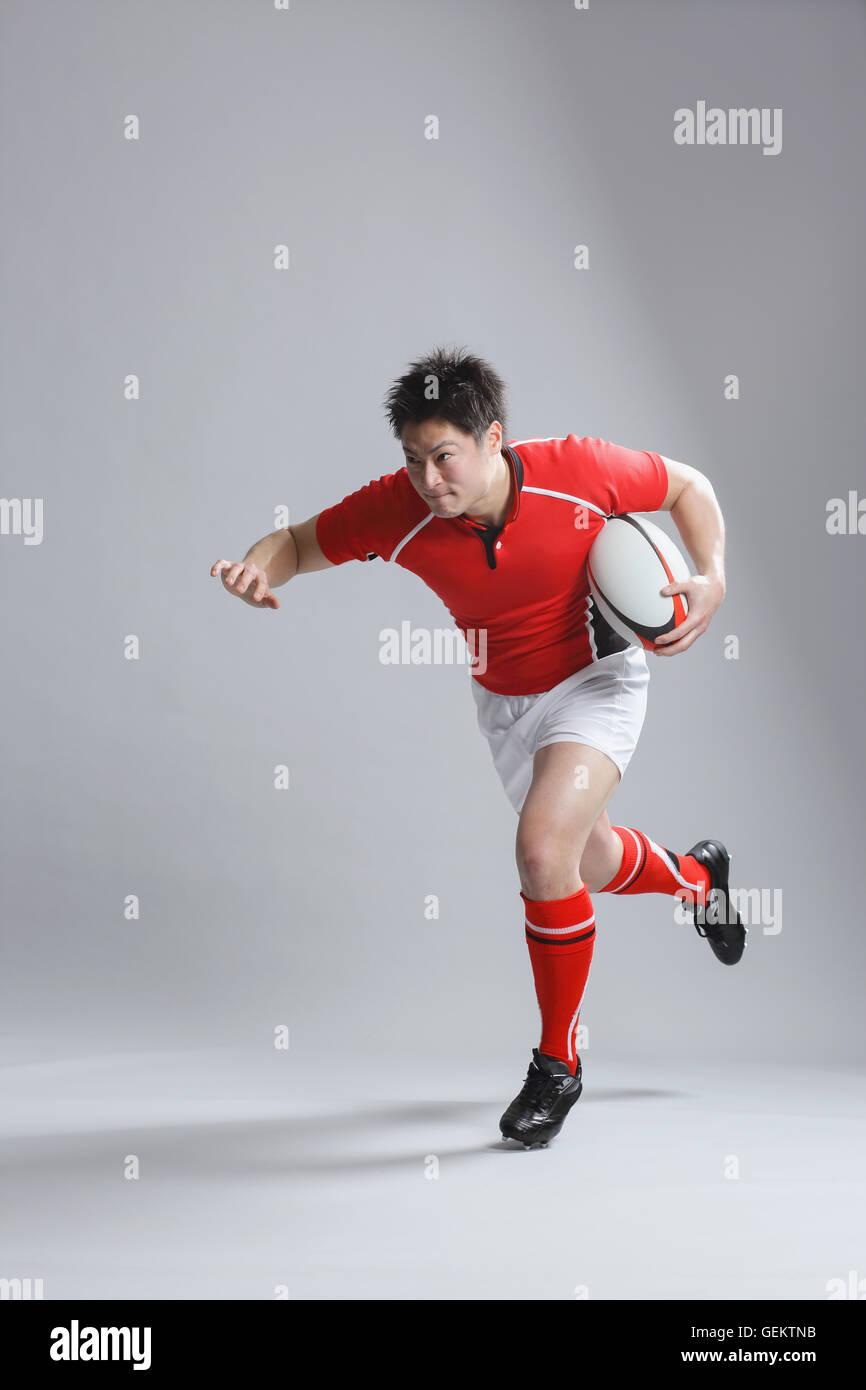 Portrait of Japanese rugby player running with ball Stock Photo - Alamy