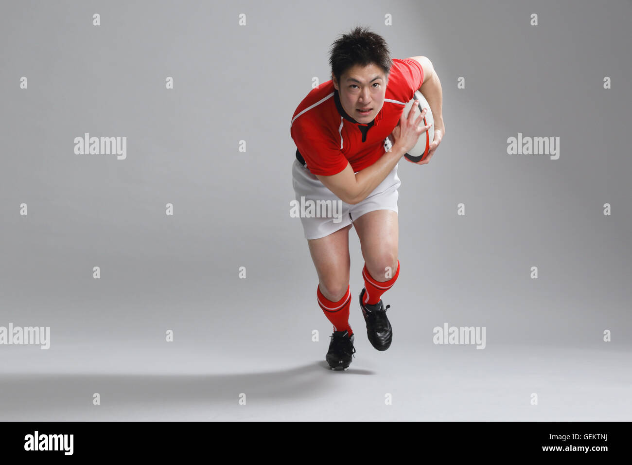 Portrait of Japanese rugby player running with ball Stock Photo - Alamy