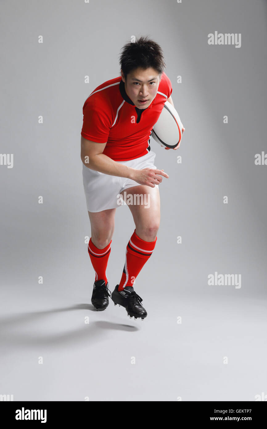 Portrait of Japanese rugby player running with ball Stock Photo - Alamy