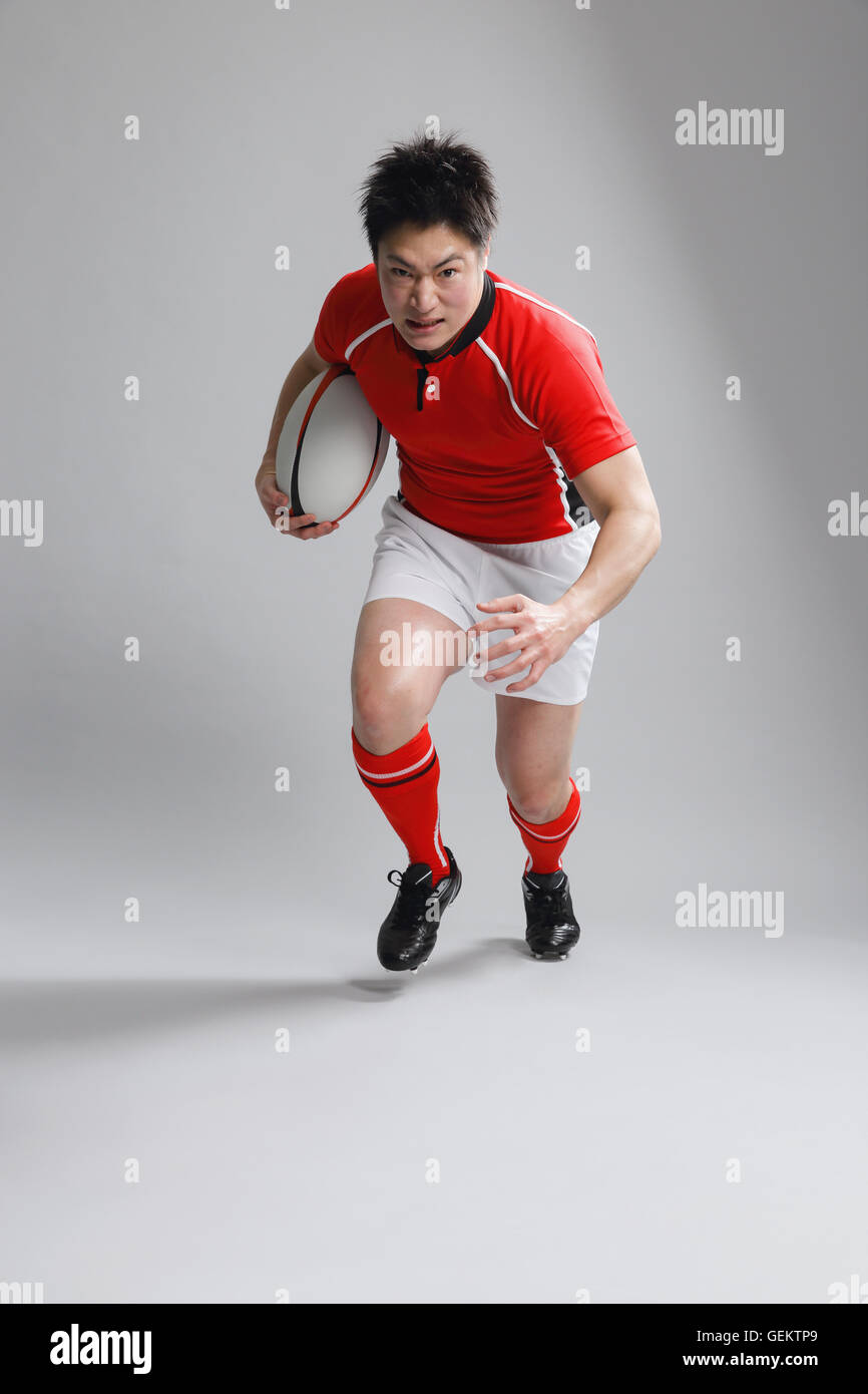 Portrait of Japanese rugby player running with ball Stock Photo - Alamy