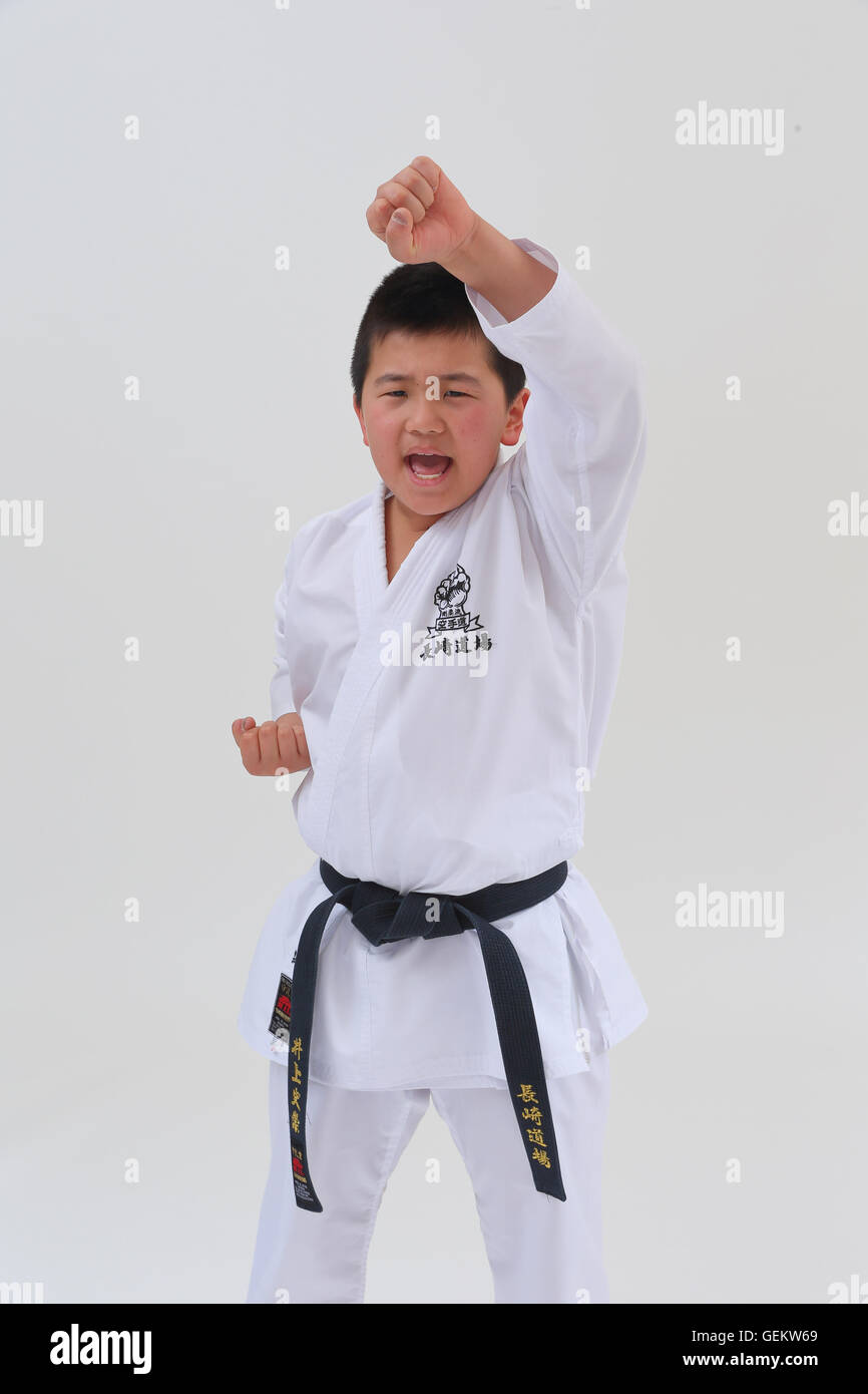 Japanese kid in karate uniform on white background Stock Photo - Alamy