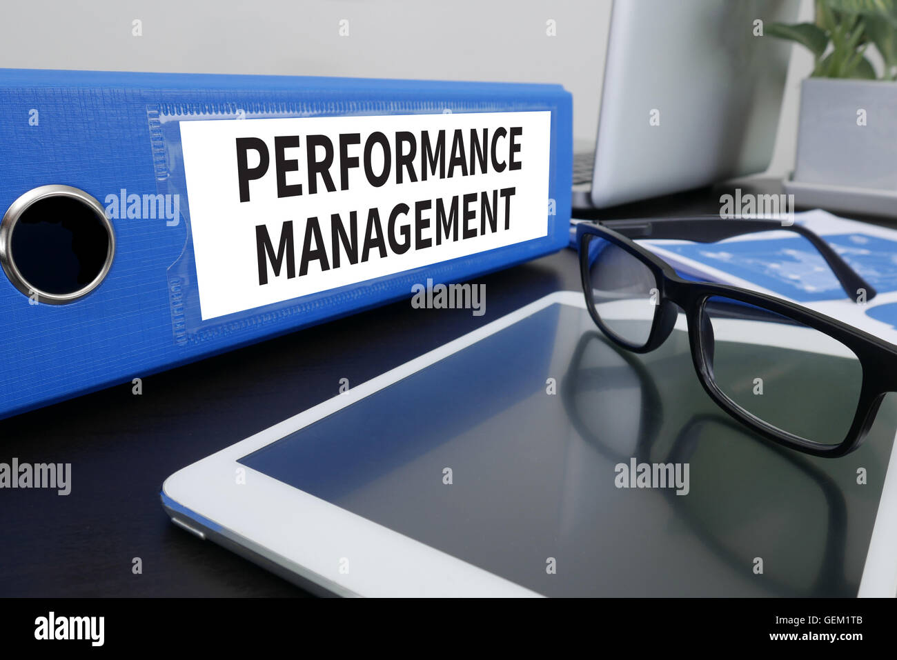 PERFORMANCE MANAGEMENT Office folder on Desktop on table with Office ...