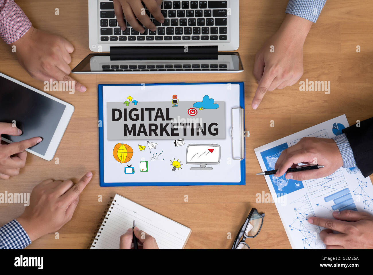DIGITAL MARKETING Business team hands at work with financial reports ...