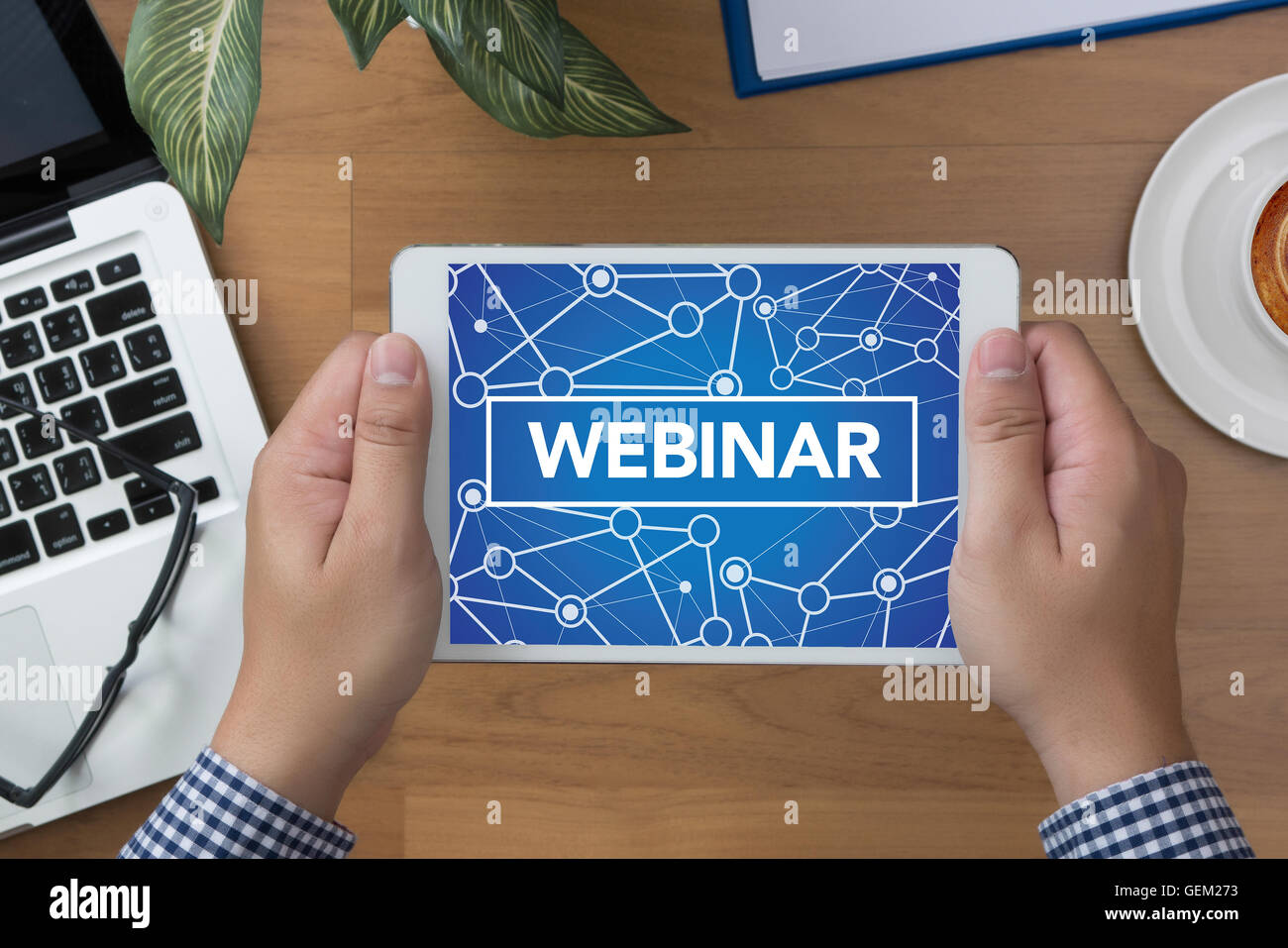 WEBINAR man hand Tablet and coffee cup Stock Photo - Alamy