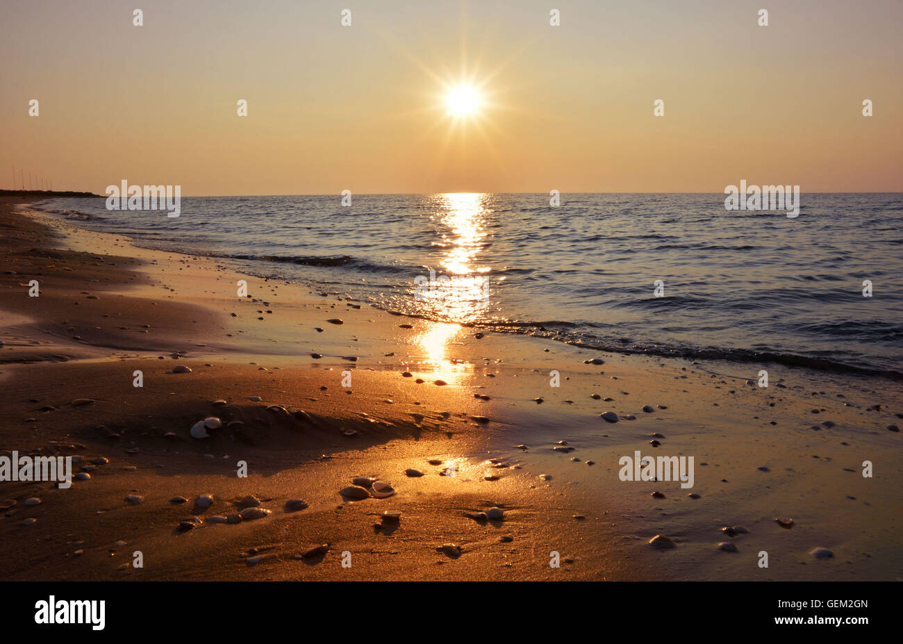 Sunrise on the beach Stock Photo - Alamy