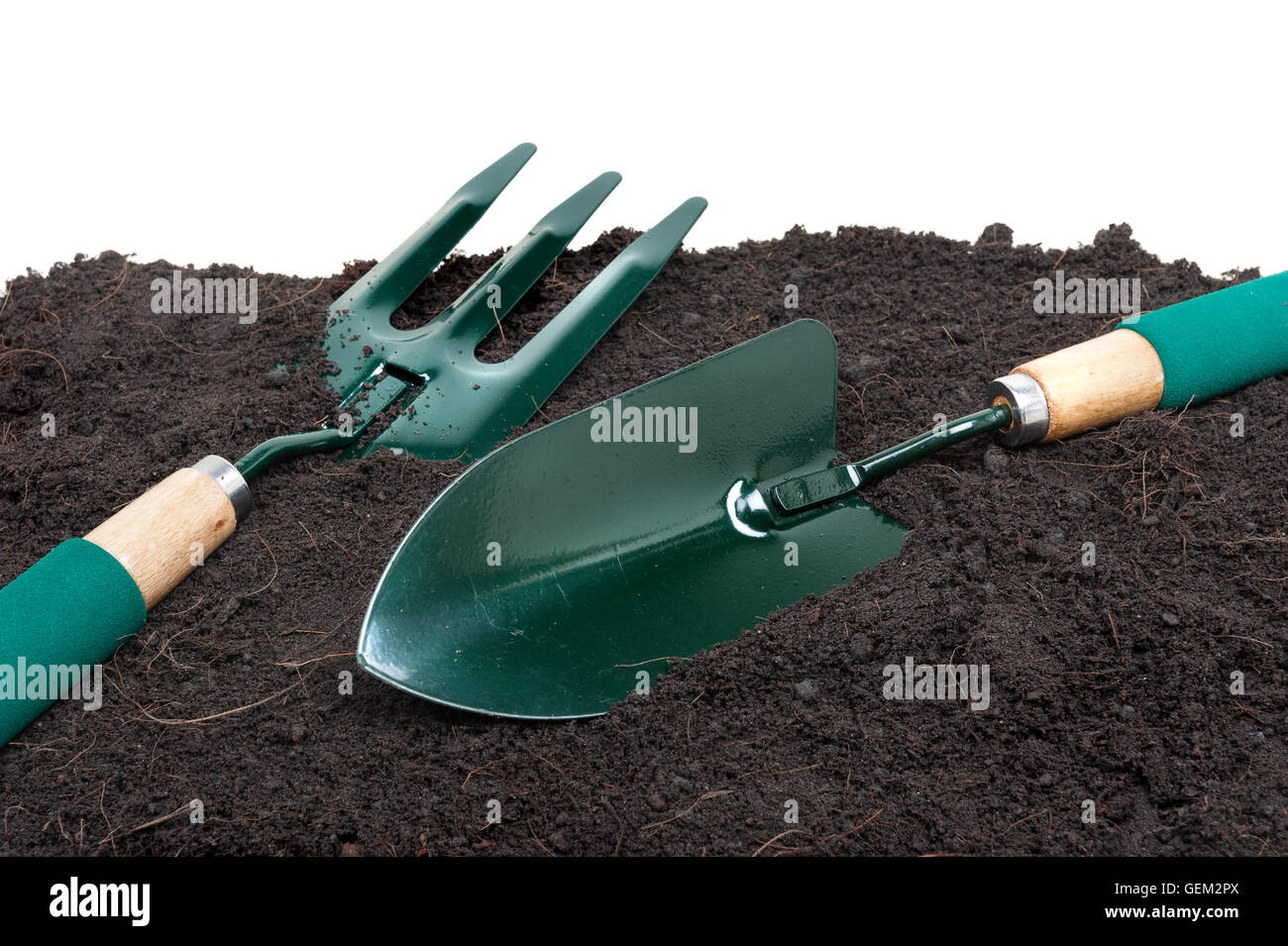 gardening tools on black soil Stock Photo - Alamy