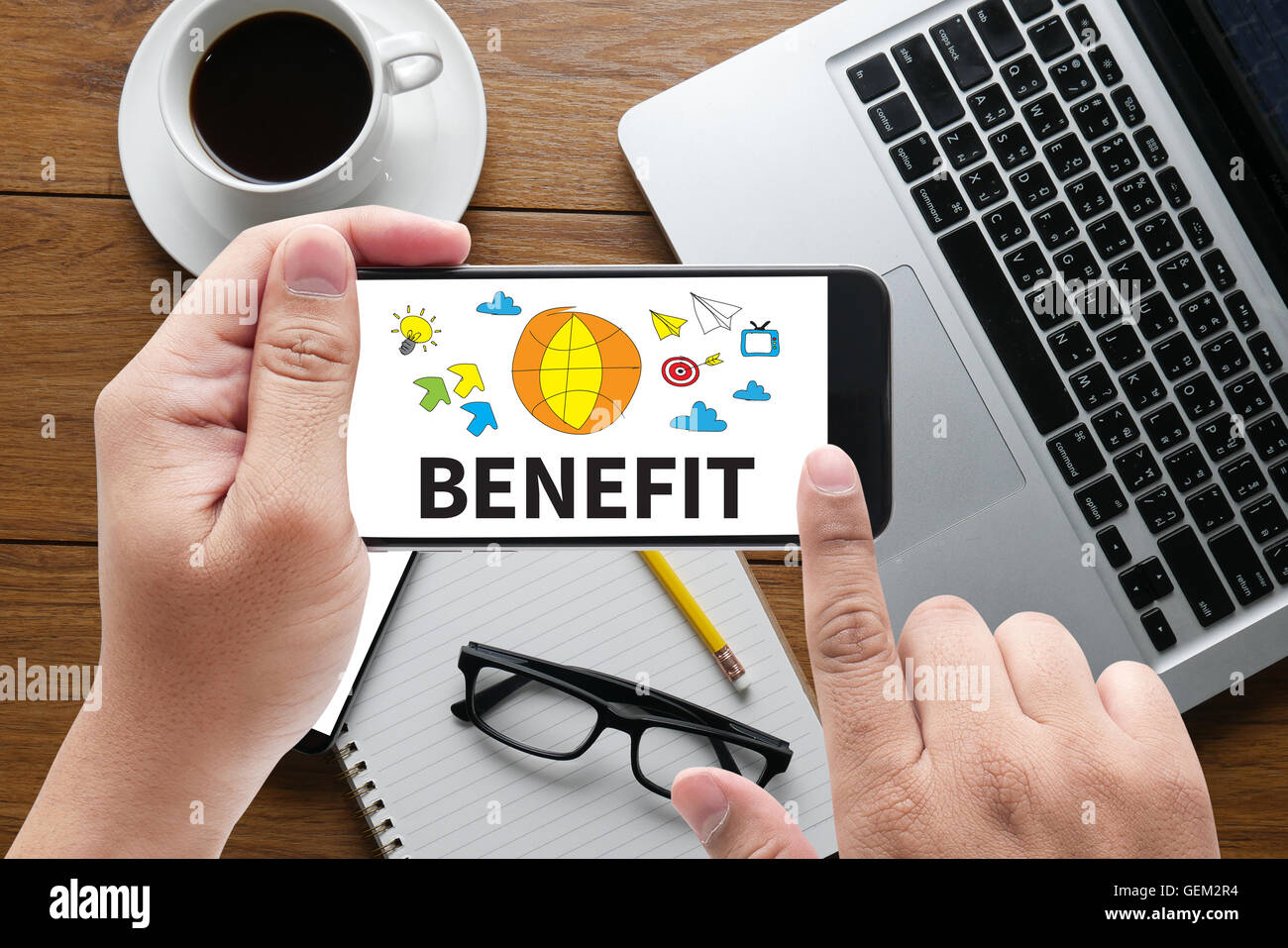 BENEFIT message on hand holding to touch a phone, top view, table ...