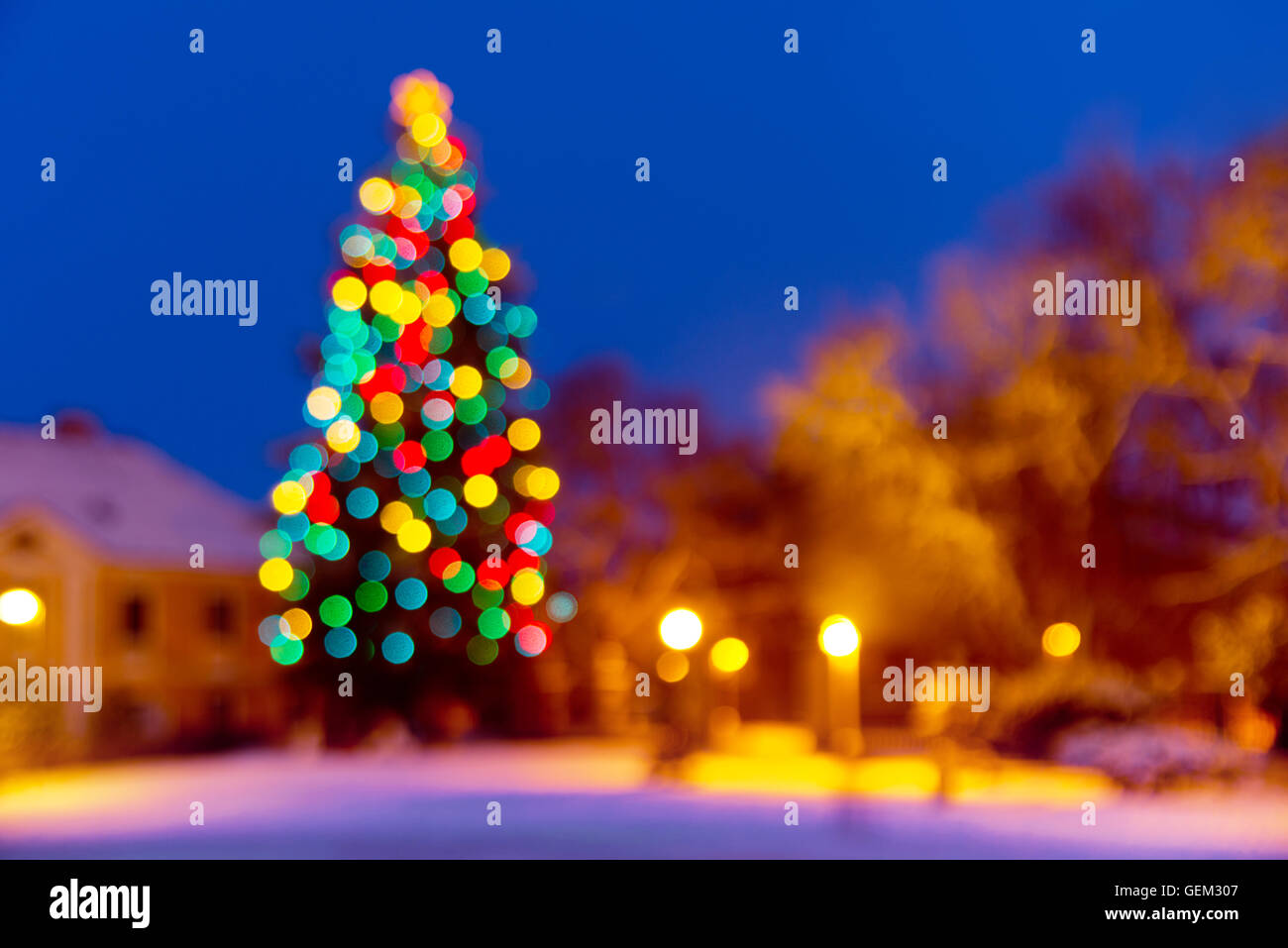 Christmas background with unfocused Christmas tree and snow by night ...
