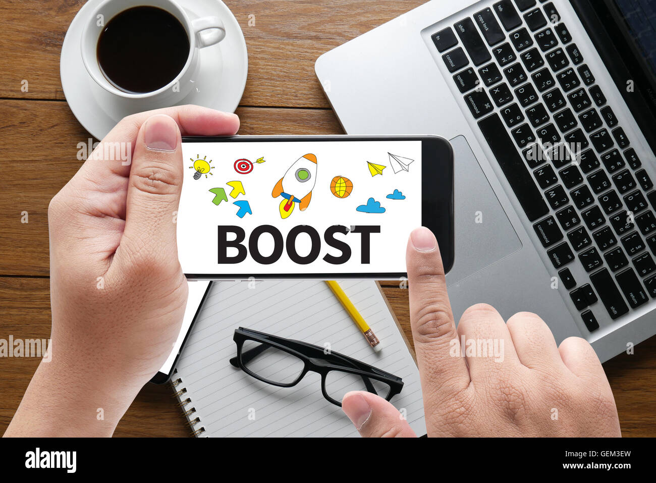 Boost message on hand holding to touch a phone, top view, table ...
