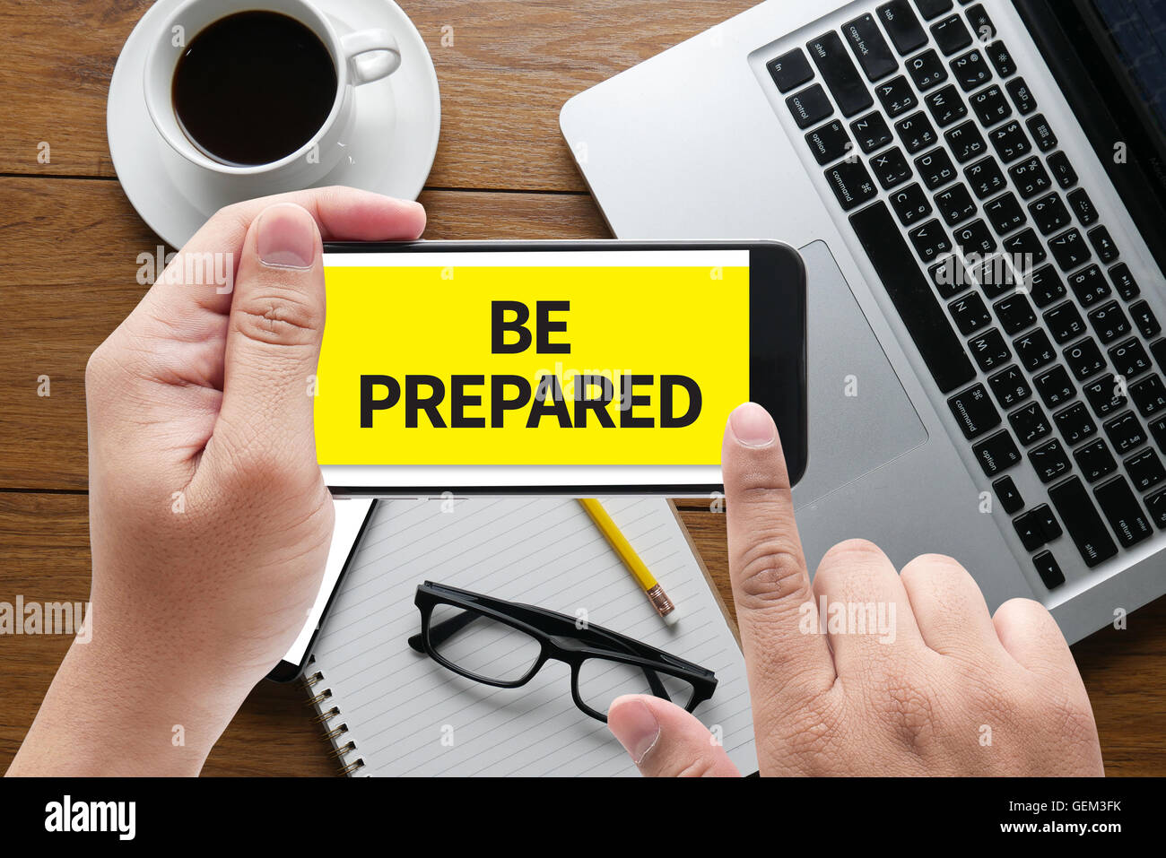 BE PREPARED concept message on hand holding to touch a phone, top view ...