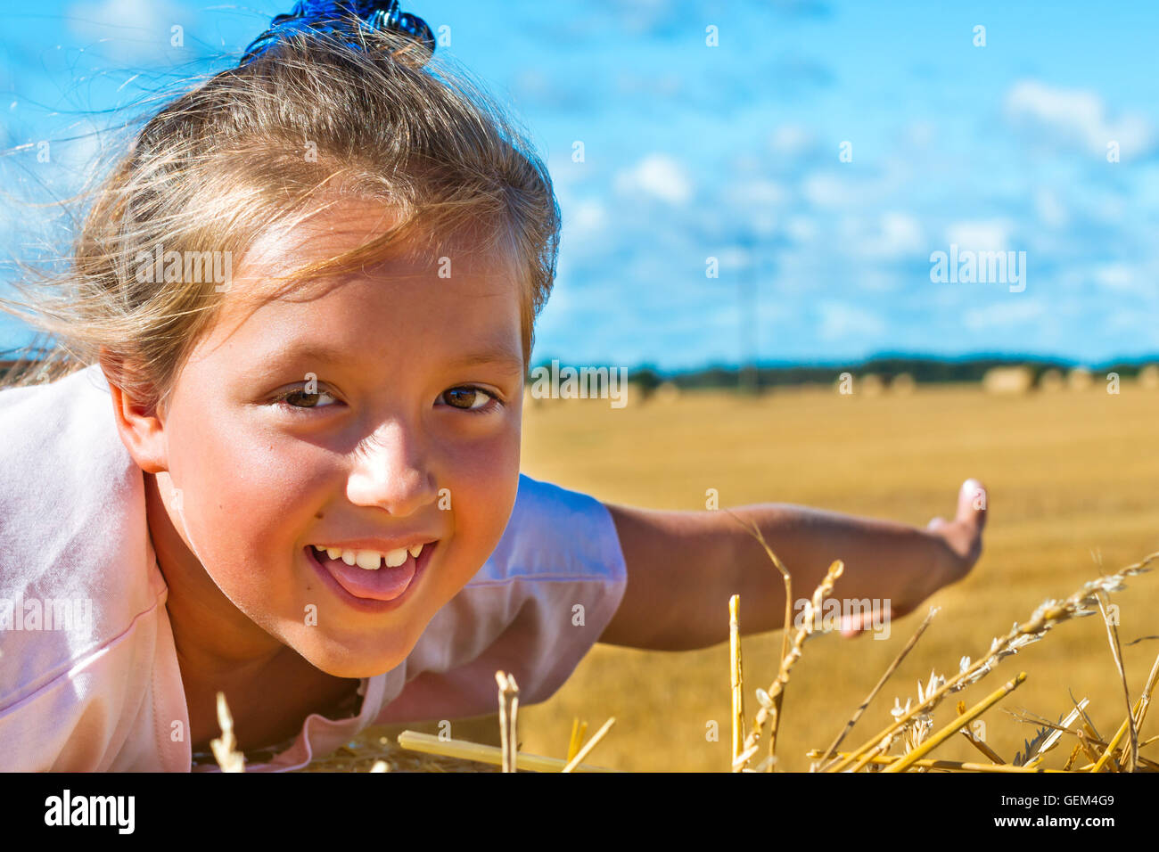 Cute young girl having fun on haystack. Stacks of straw - bales of hay ...