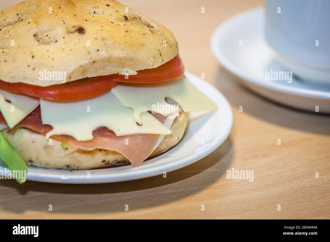 Breakfast ham, cheese and tomato bun on a plate Stock Photo - Alamy